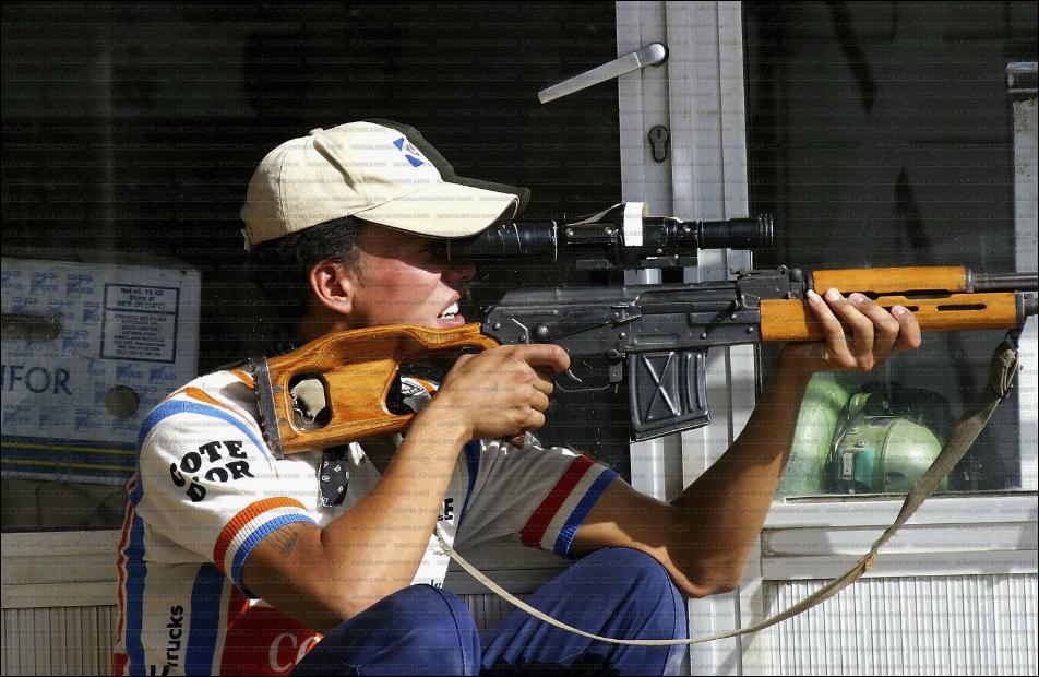 A U.S. special operations sniper locks on a target near the cemetery in ...