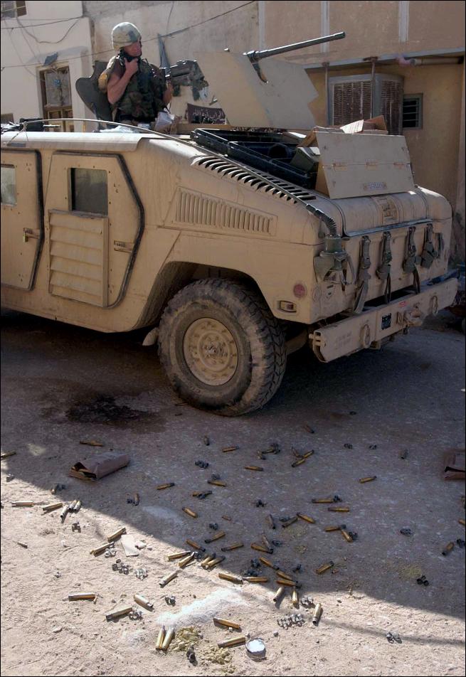 A U.S. special operations sniper locks on a target near the cemetery in ...