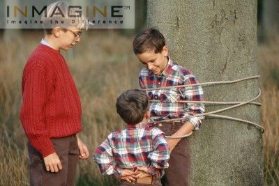 Boy tied to a tree