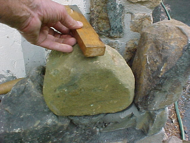 8. Lay down an ample bed of mortar in the spot for the stone.